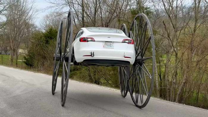 Driving a Tesla Upside Down With 10 Feet Tall Wheels | Torque News